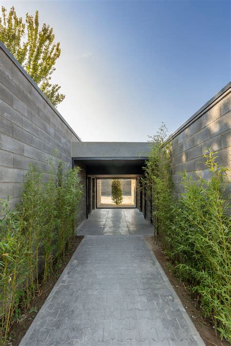 Hooba Design Group Arranges Concrete Showroom Around Fish Pond And Greenery