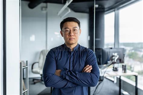 Portrait Of Serious Asian Developer Businessman With Crossed Arms Looking Concentrated At