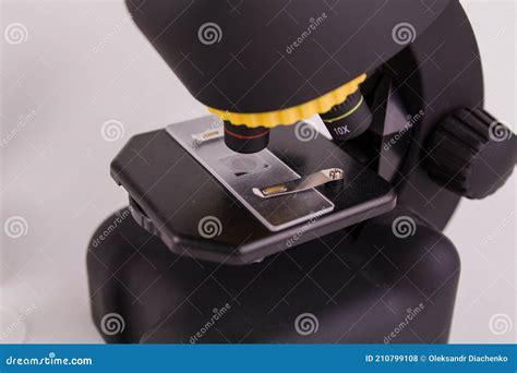 Glass For Analysis Under A Microscope With A Sample On A White