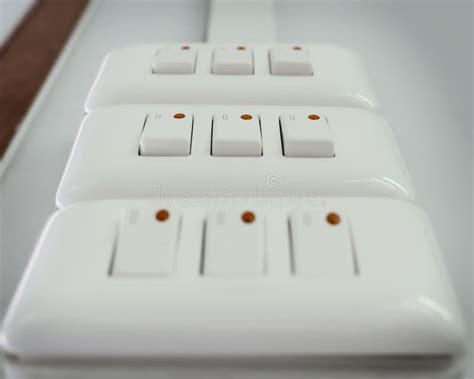Low Angle Shot Of White Gang Way Light Switches On A Wall Stock Image Image Of Tool Energy