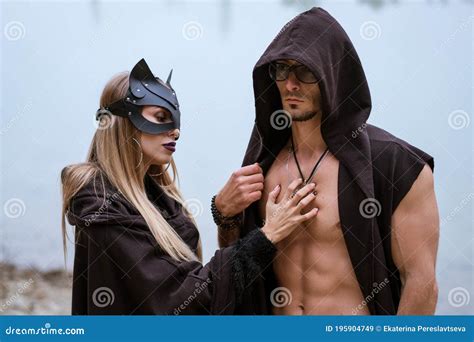 A Cat Girl Leads A Man S Torso With Her Hand Against The Backdrop Of A Pond Stock Image Image