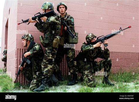 980605-A-3559S-008 Four Latvian soldiers keep a sharp look out as they ...