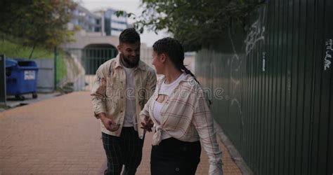 Young Funny Couple Kisses In A Passion At The City Slow Motion Stock