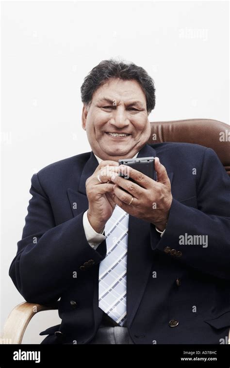 Portrait Of A Businessman Operating A Personal Data Assistant Stock