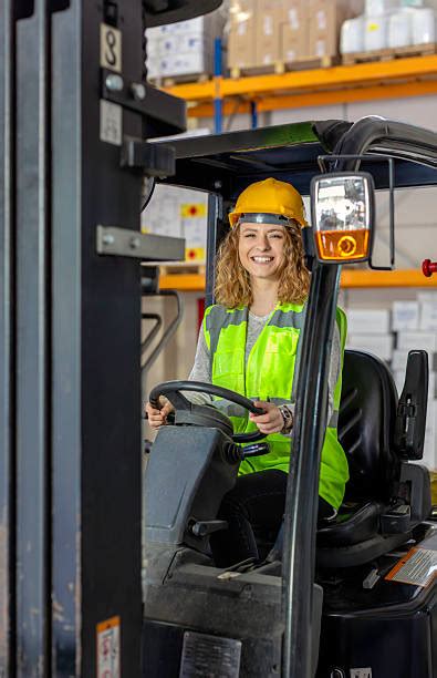 280 Forklift Operator Uniform And Helmet At Work In Warehouse Stock