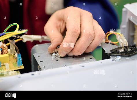 Assembly Process Of Microwave Oven Electrical Components On Conveyor System In Manufacturing