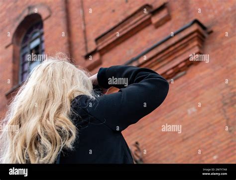 Blonde Girl With Long Beautiful Hair Making Photo On Blurred Background