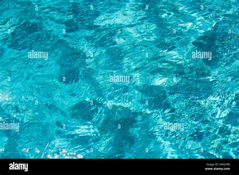 Abstract ripple wave and clear turquoise water surface in swimming pool, blue water wave for ...
