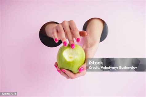아름다운 여자의 손이 분홍색 배경에 사과를 들고있다 아름다운 매니큐어 컨셉 클로즈업 가냘픈에 대한 스톡 사진 및 기타 이미지 가냘픈 개념 과일 Istock