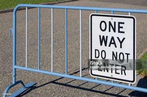 gated area with white and balck sign reading one way do not enter stock