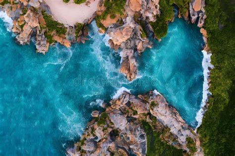 aerial view top down seashore big wave crashing on rock cliff stock