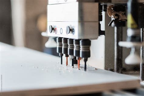 Hinge Boring Machinery Drilling 5 Holes In A Cabinet Door By Stocksy Contributor Lior Lone