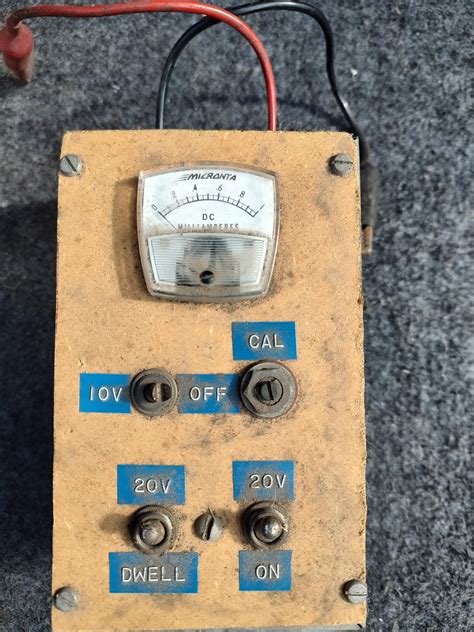 Small Homemade Electronic Device With Two Test Leads Coming Out Of It