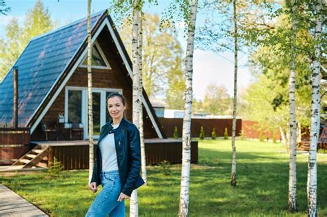 Premium Photo Portrait Of Cheerful Woman Standing In Front Of Aframe