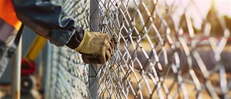 Premium Photo Securing The Border Installing Chain Link Wire Fences