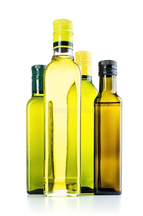 Four Full Closed Glass Bottles With Olive Oil Isolated On A White
