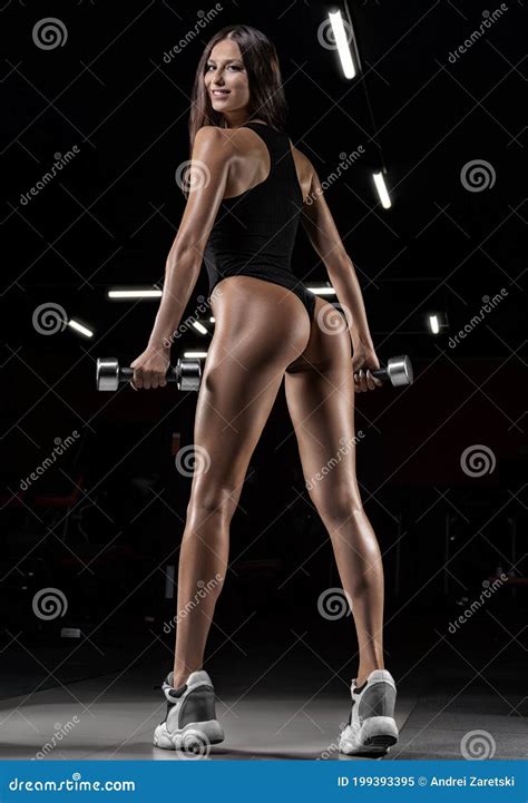 Tall Adult Woman With Beautiful Hair Posing With Dumbbells In Her Hand