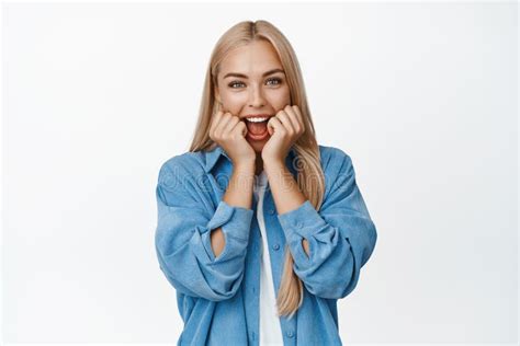 Cute And Silly Blond Girl Squeeze Her Cheeks And Smiling Looking Amused At Camera Checking