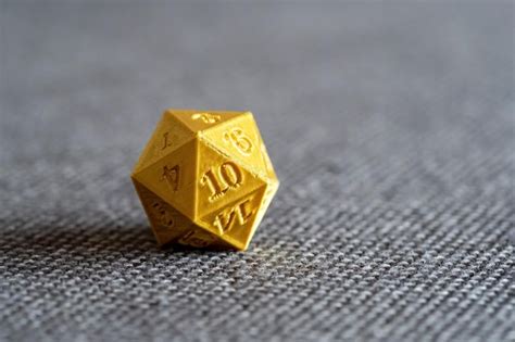 Premium Photo Golden 3d Printed D20 Rpg Game Dice On A Bed Object