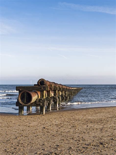 Old Broken And Rusted Pipe Leading Into The Sea With Copy Space Stock
