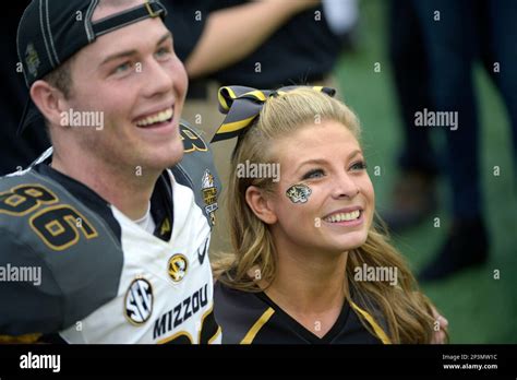 A Missouri Cheerleader Stands With Tight End Jake Hurrell 86 On The Field After The Citrus