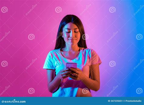 Social Networks Asian Lady Looks At Smartphone And Types Stock Image
