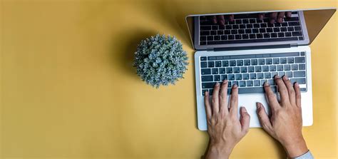Man Using Keyboard Computer Laptop On Yellow Background Copy Space
