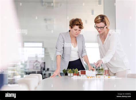 Female Architects Discussing Model In Conference Room Stock Photo Alamy