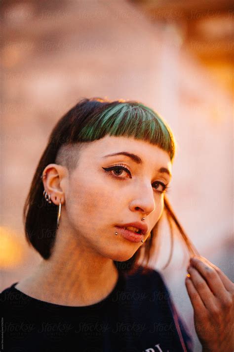 Woman With Piersing Holding Hair By Stocksy Contributor Javier Díez