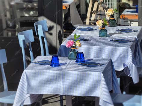 Premium Photo Line Of Cute Square Tables With Patterned Blue And