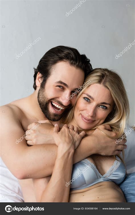 Cheerful Sexy Couple Smiling While Looking Camera Fotografía De Stock