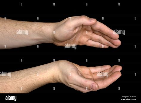 Male Hands Enclosing And Encompassing And Cupping Against Black Stock