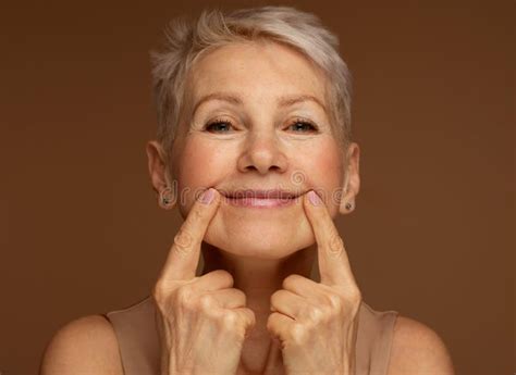 Gorgeous Happy Mature Woman Senior Older Year Lady Looking At Camera Touching Her Face Over