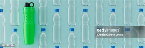 Green Reusable Drinking Bottle Surround By Everyday Purchased Water