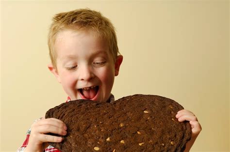 Premium Photo Young Boy Age 5 Getting Ready To Bite Into A Gigantic