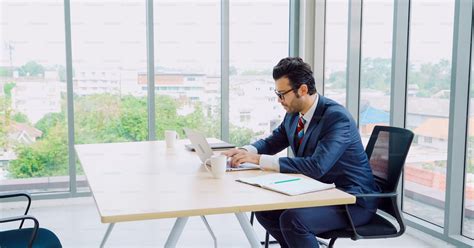 Business People Working At Table In Modern Office Room While Analyzing