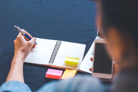 Premium Photo Woman Hand Is Writing On A Note Pad With A Pen In The Office