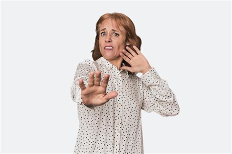 Premium Photo Redhead Midaged Caucasian Woman In Studio Being Shocked Due To An Imminent Danger