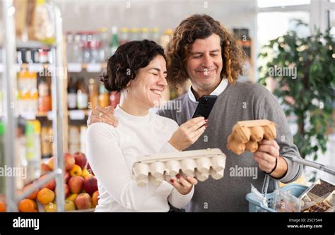 Checking Expiration Date Of Eggs Wife And Husband Shoppers Scans Qr Code On Label Of Eggs