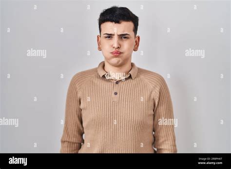 Non Binary Person Standing Over Isolated Background Puffing Cheeks With Funny Face Mouth