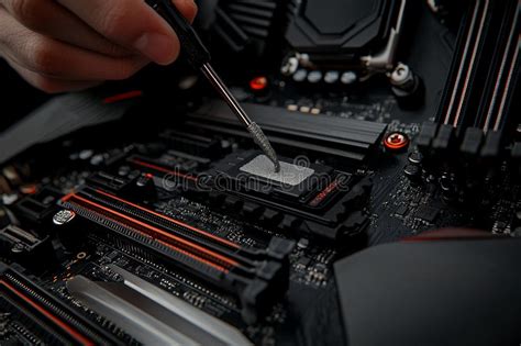 An Adult Male Hand Applies Thermal Paste To A Computer Motherboard S Cpu Socket Using A Small