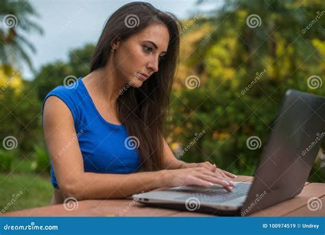 Young Female Freelancer Working At Project On Her Laptop In Tropical
