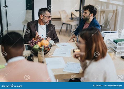 Diverse Business Group Collaborating On Market Analysis Strategic Planning And Technology For