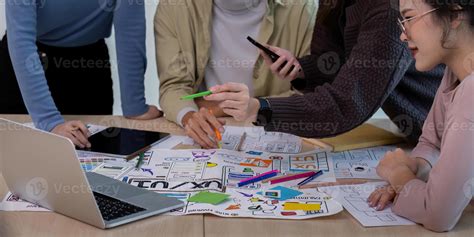 Creative Ux Developer And Ui Designer Team Brainstorming Session With Digital Devices And Design