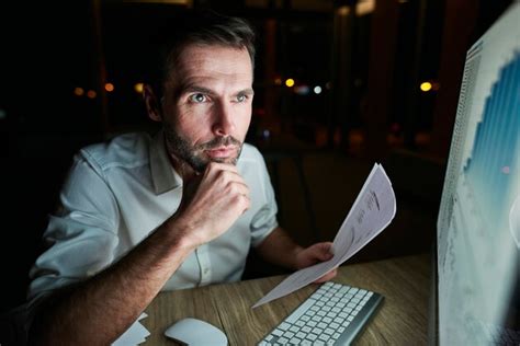 Premium Photo Focused Man Analyzing Document At Night