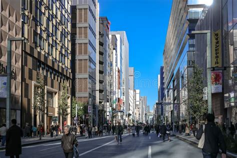 Crowded Street Scene With Pedestrians In Urban Tokyo City During