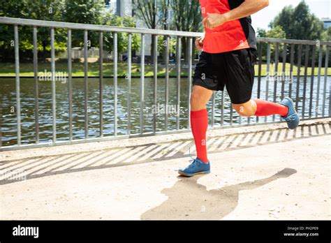 Low Section View Of A Man Running On Sidewalk At Morning Stock Photo Alamy