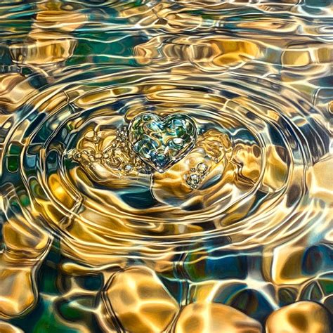 A Glass Heart Floats On Shimmering Golden Water With Ripples Around It