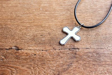 Closeup Christian Cross And Bible On Old Wooden Table With Sunlight