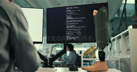 Robotics Development And Person At Computer Screen With Prosthetic Leg Coding Or Innovation In
